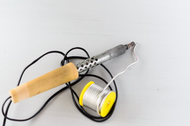 Solder Wire and Soldering Iron with Wooden Handle on Gray Background ...