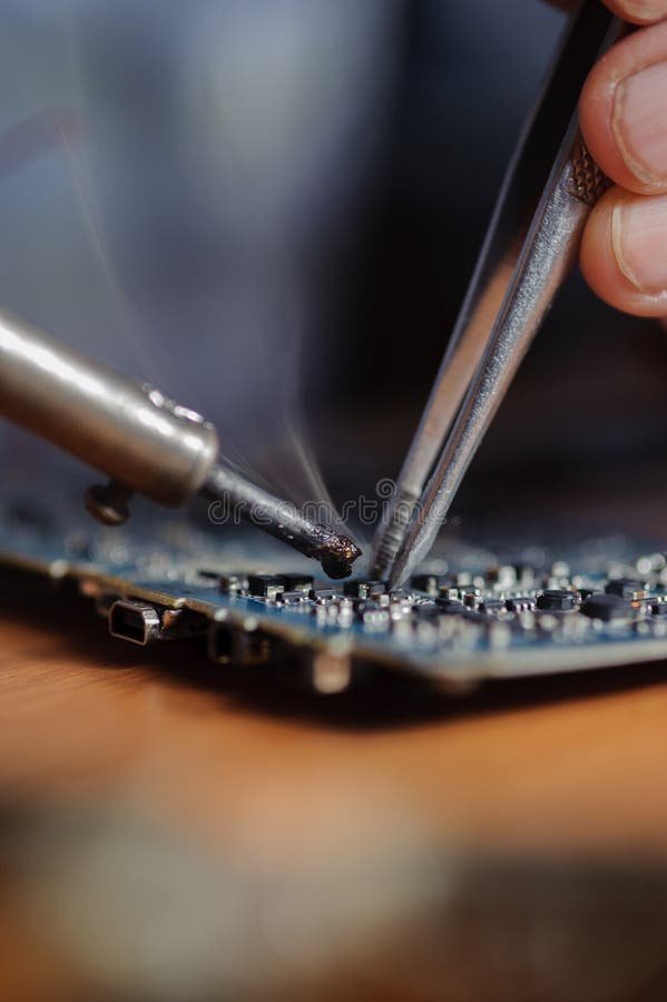 Soldering computer board stock image. Image of examining - 109537533