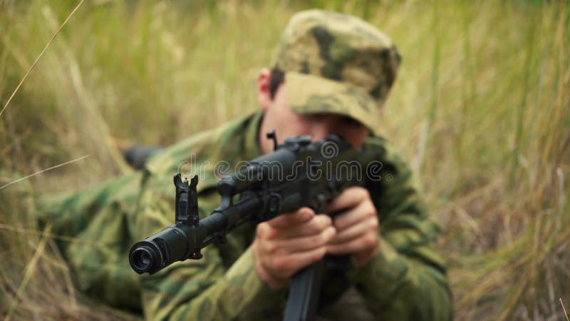 Soldier Aiming from a Machine Gun while in Ambush. Stock Video - Video ...