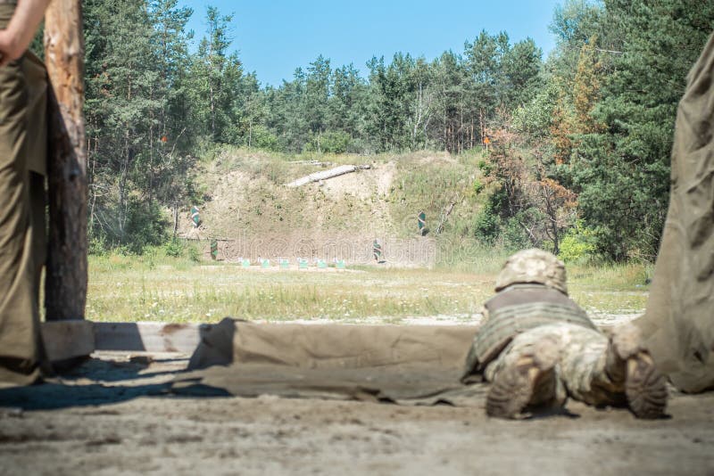 Soldier Aims at a Target on a Military Training Ground Lying Down ...
