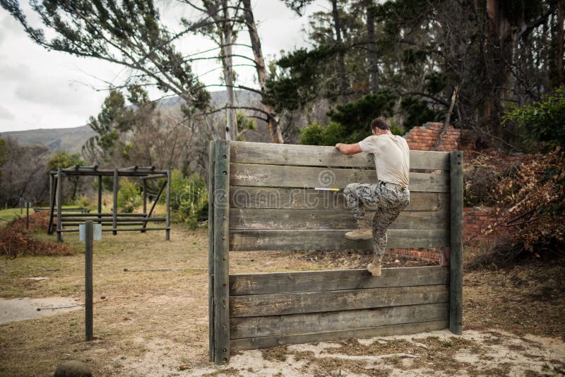Soldier Climbing Wooden Wall in Boot Camp Stock Image - Image of ...