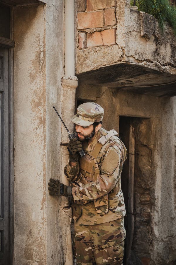 Soldier Communicates with Transceiver before Entering in a House Stock ...