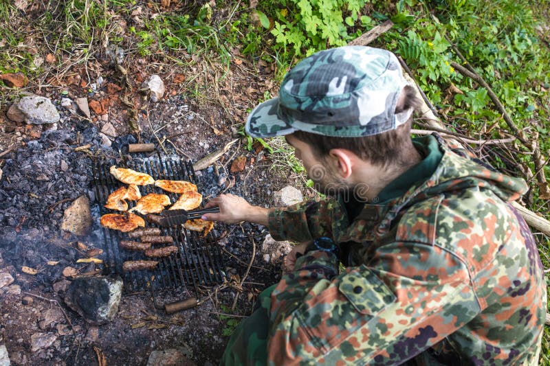 Soldier Grilling Chicken and Sausages in the Woods Stock Image - Image ...