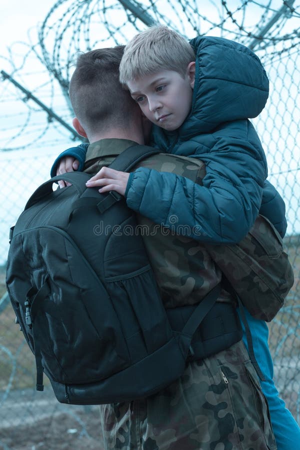 Soldier hugging little son stock photo. Image of backpack - 57626156