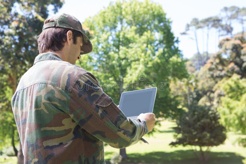 Soldier Looking at Tablet Pc in Park Stock Photo - Image of countryside ...