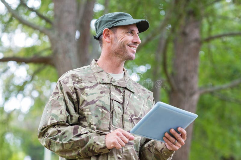 Soldier Looking at Tablet Pc in Park Stock Photo - Image of countryside ...