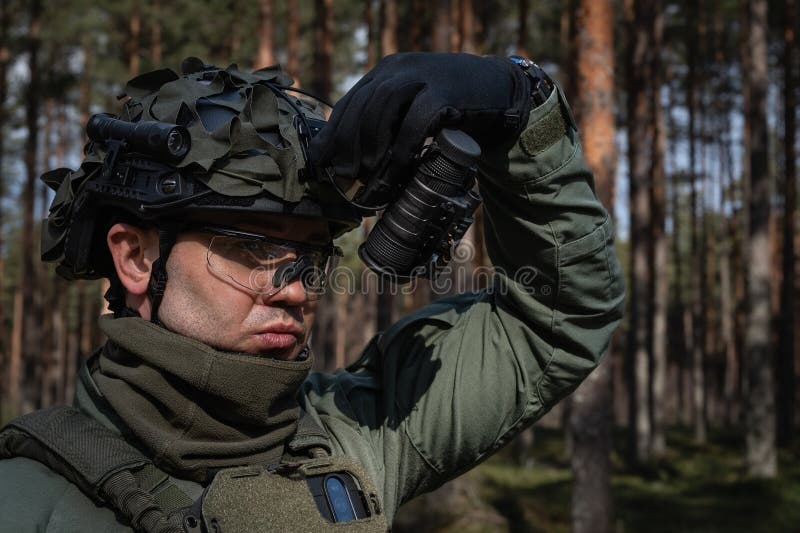 A Soldier Lowers His Helmet-mounted Night Vision Device for Use while ...
