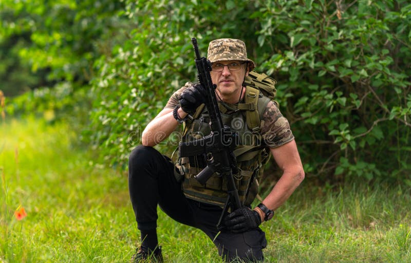 Soldier or Mercenary Crouching on One Leg, Looking at the Camera Stock ...