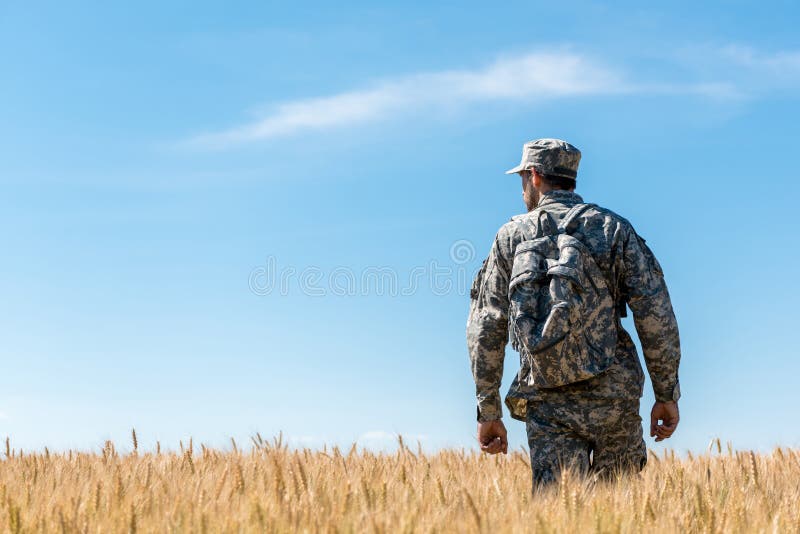 Soldier in Military Uniform with Backpack Standing in Field Stock Image ...
