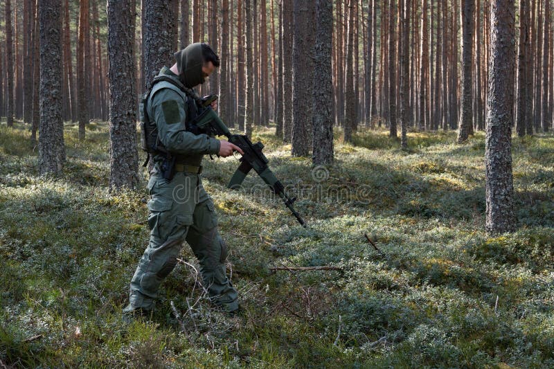 A Soldier Patrols the Forest, Using a Smartphone Mounted on Tactical ...