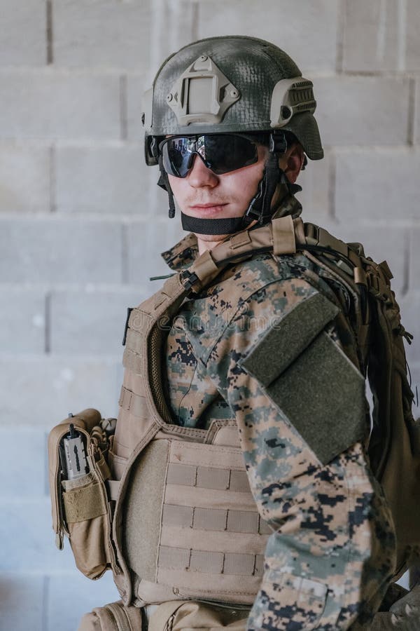 Soldier Preparing Tactical Protective and Communication Gear for Action ...