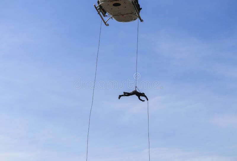 Soldier Rappelling from Helicopter in Blue Sky Editorial Stock Image ...