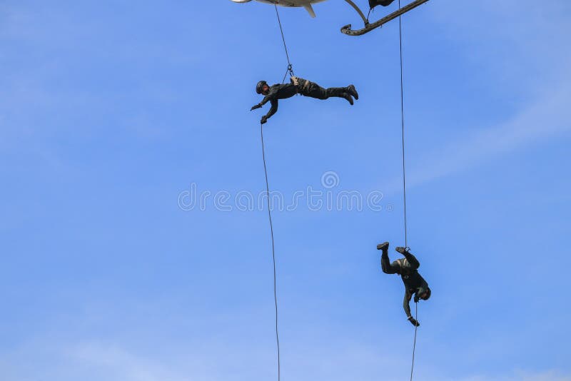 Soldier Rappelling from Helicopter in Blue Sky Editorial Stock Image ...