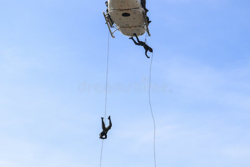 Soldier Rappelling from Helicopter in Blue. Sky with Blur Propell Stock ...
