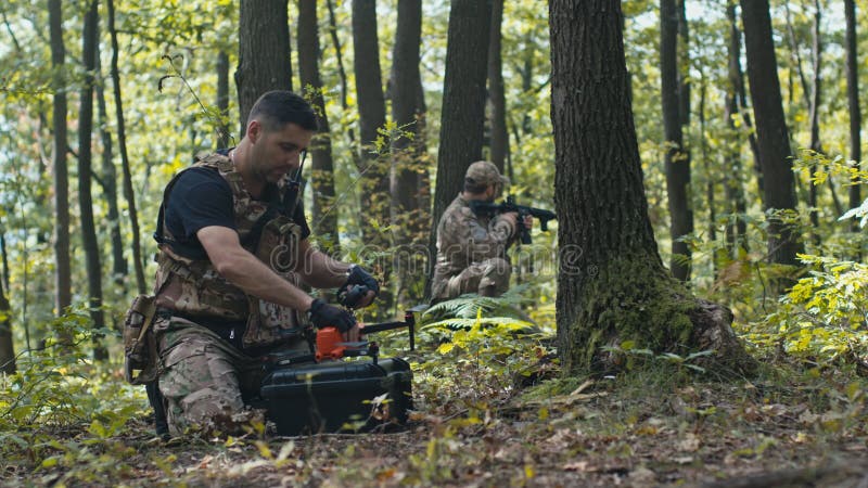 A Soldier Setting Up the Drone for Flight while His Comrade Guards Him ...