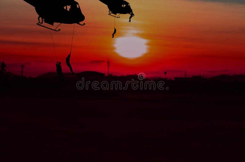 Soldier Silhouette in Rappelling Climb Down from Helicopter on Sunset ...