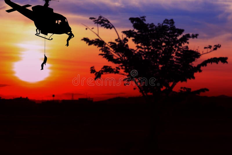 Soldier Silhouette in Rappelling Climb Down from Helicopter on Sunset ...