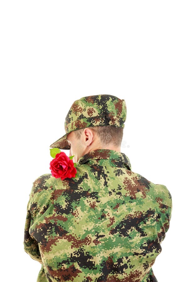 Soldier with Turned Back Holding Red Rose Over Shoulder Stock Photo ...