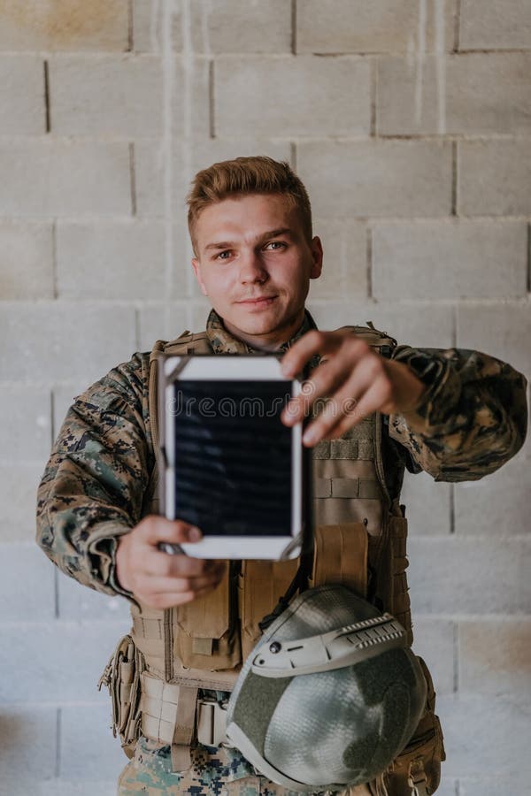 Soldier Using Tablet Computer Against Old Brick Wall Stock Image ...