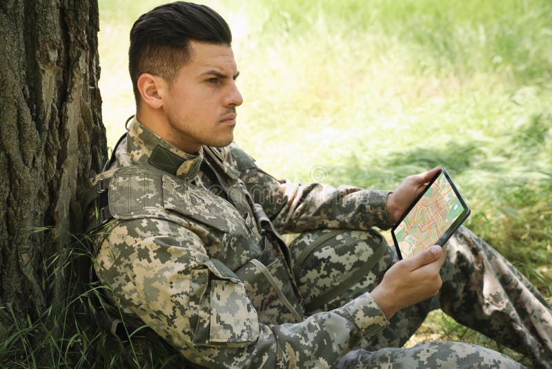 Soldier Using Tablet Near Tree in Forest Stock Image - Image of sitting ...