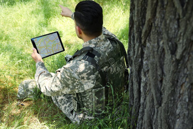 Soldier Using Tablet Near Tree in Forest Stock Image - Image of ...