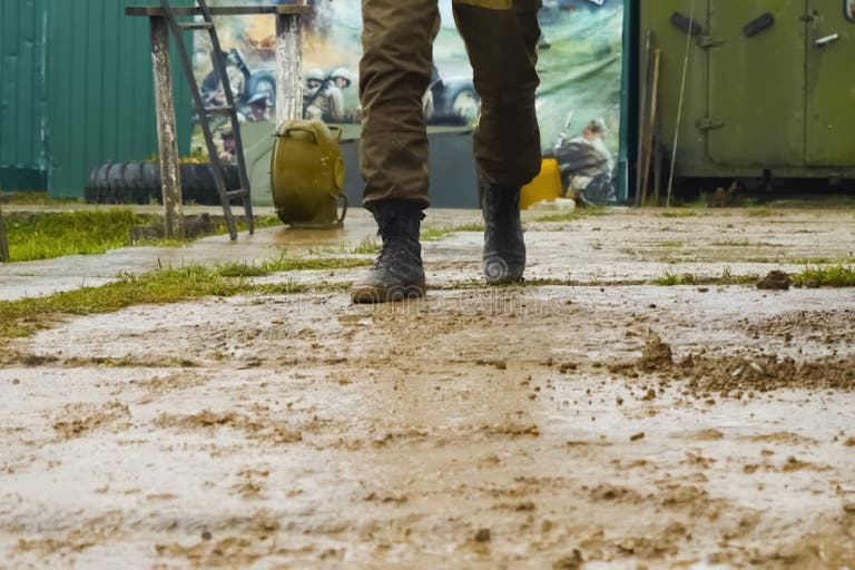 Soldier in Work Clothes and Boots Walks on Muddy Ground Stock Image ...