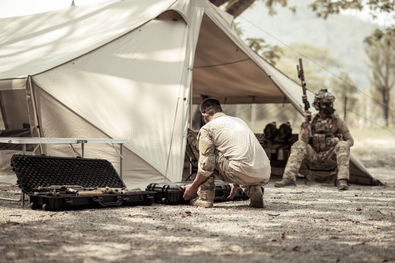 Soldiers in Camouflage Uniforms Planning on Operation in the Camp ...