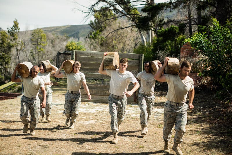 Soldiers Carrying a Tree Log Stock Photo - Image of caucasian, ground ...