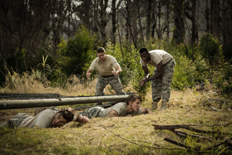 Soldier Crawling Under the Net during Obstacle Course Stock Photo ...