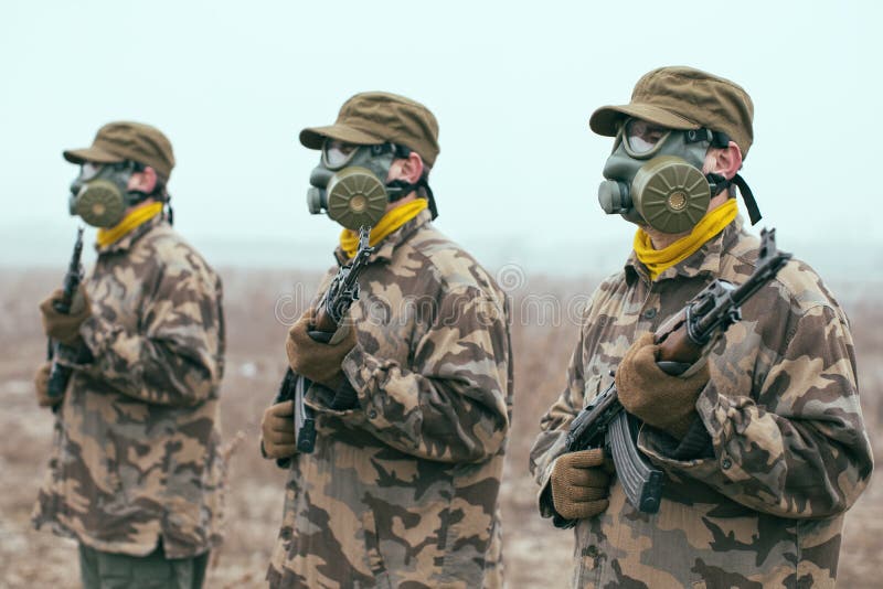 Soldiers with Gas Mask and Automatic Guns Standing Ready Stock Image ...