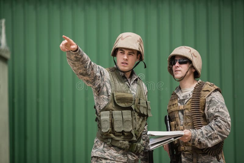 Soldiers Showing Direction To His Colleague Stock Image - Image of ...