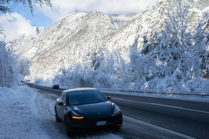 Solid Black Tesla Model 3 Dual Motor with a Snow-covered Mountain on a ...