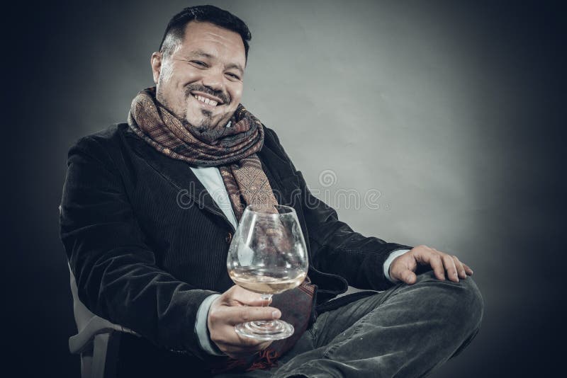 Solid Cheerful Man in Kerchief Sitting with Glass of Wine Stock Photo ...