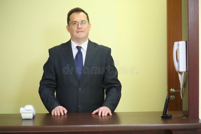 Solid Concierge Behind the Counter at His Stock Photo - Image of ...