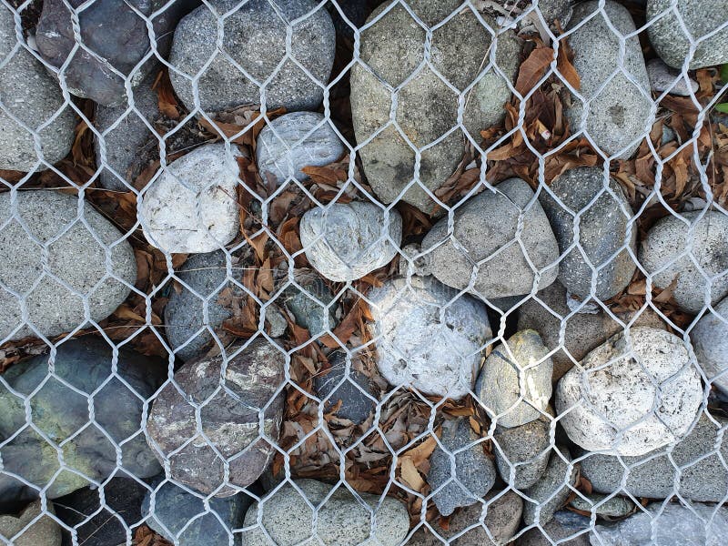 Solid Heavy Stone Covered Metal Net Stock Image - Image of metal, stone ...