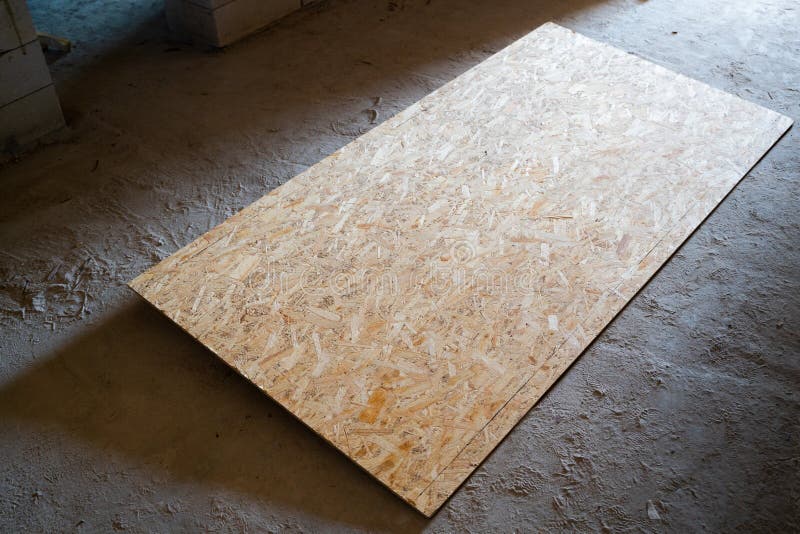 A Solid Rectangular Sheet of Oriented Strand Board Lies on the Floor at ...