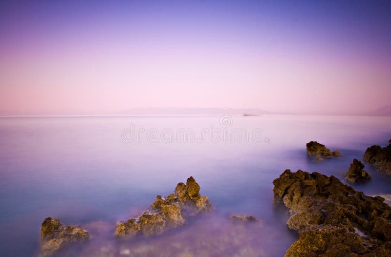 Solid Rocks and a Beautiful Ocean at Dusk Stock Photo - Image of cloud ...