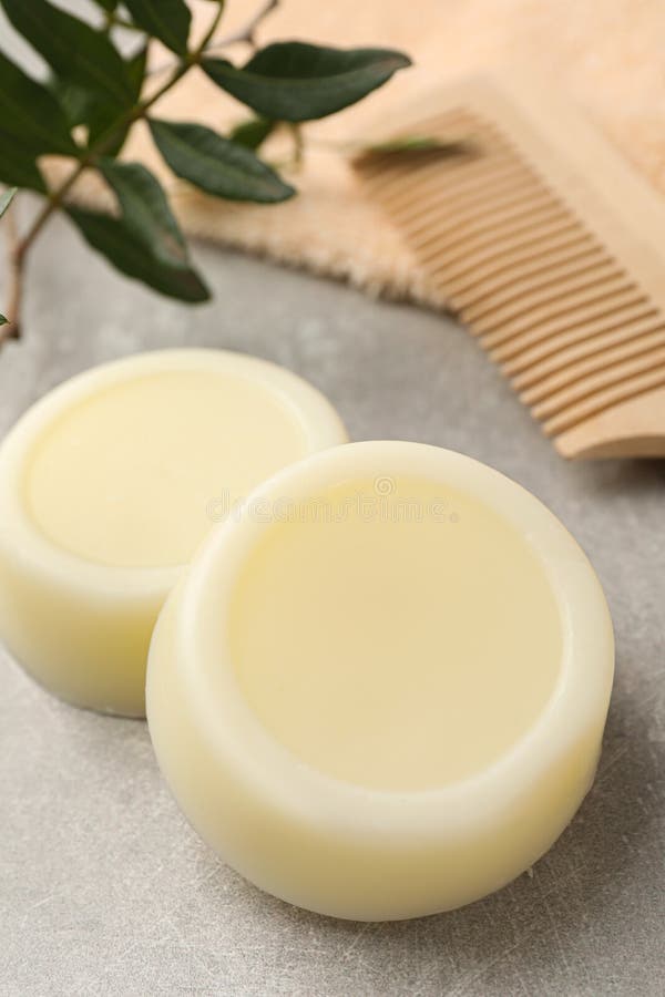 Solid Shampoo Bars, Green Twig and Comb on Grey Table Stock Image ...
