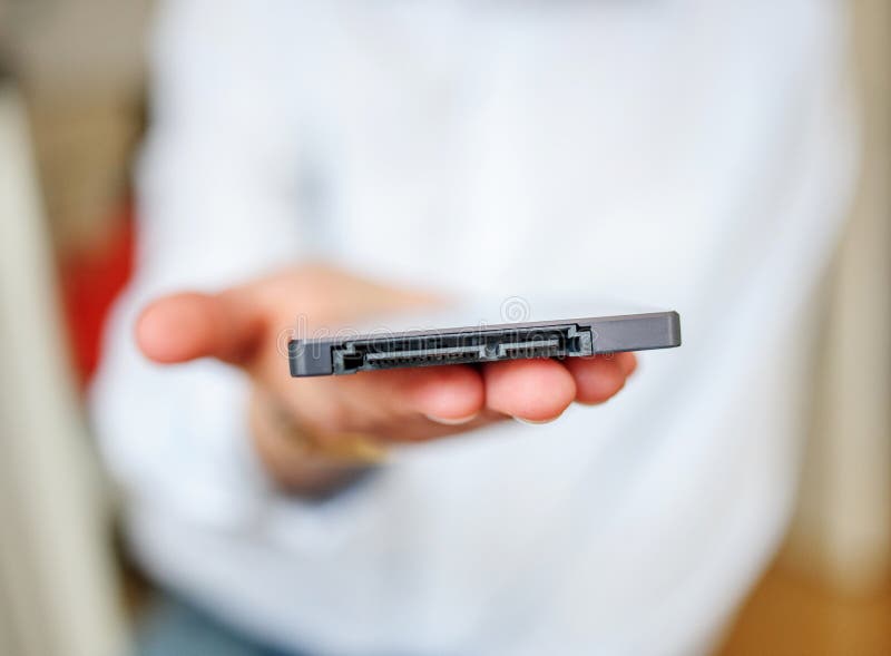 Solid state drive in hands stock photo. Image of advertisement - 69427758