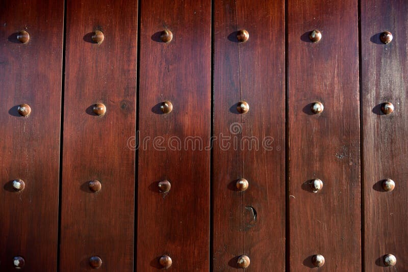 A Solid Wooden Door Close-up with Rows of Metal Studs Stock Image ...