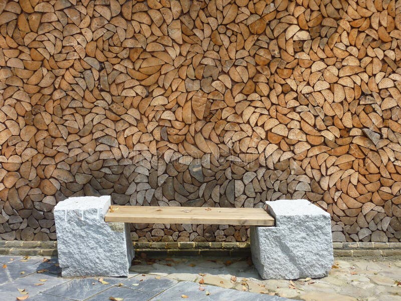 A Solid Wooden and Stone Bench in Front of a Detailed Wooden Wall Stock ...