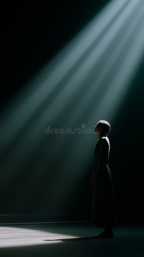 Silhouetted Figure in a Beam of Light during a Dramatic Performance in ...