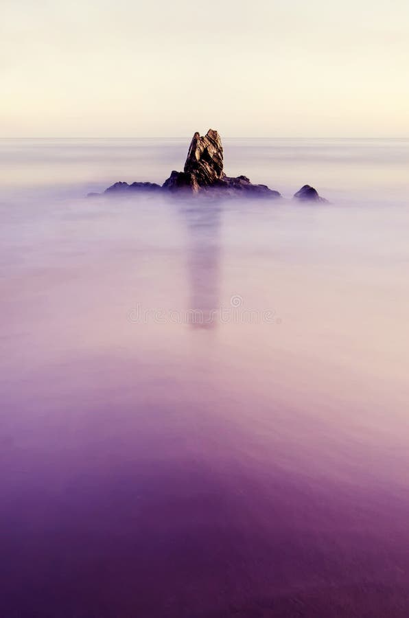 Solitary rock in the ocean stock photo. Image of nature - 28778024