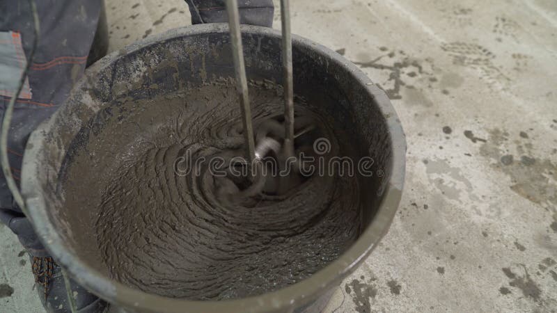 The Solution in the Bucket is Mixed Using a Construction Mixer. Mixing ...