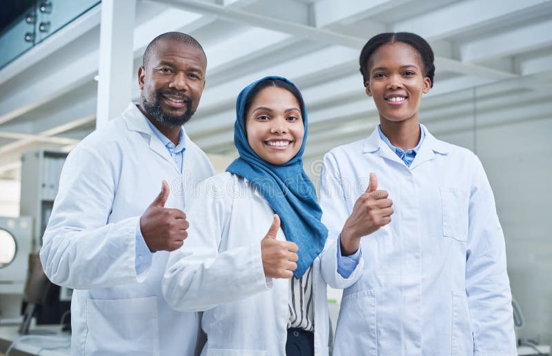 We Solved it Together. Portrait of a Group of Scientists Showing Thumbs ... We Solved it Together. Portrait of a Group of Scientists Showing Thumbs ...