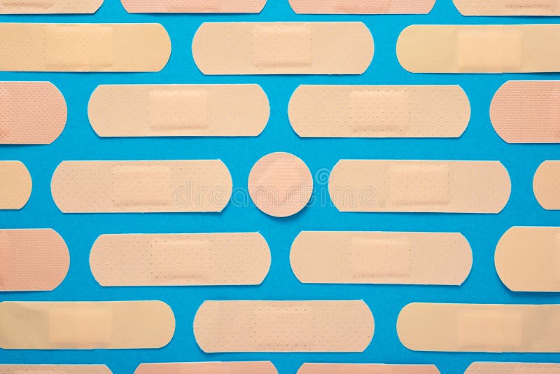 Some Band-aids on a Blue-green Table Stock Photo - Image of bandaids ...