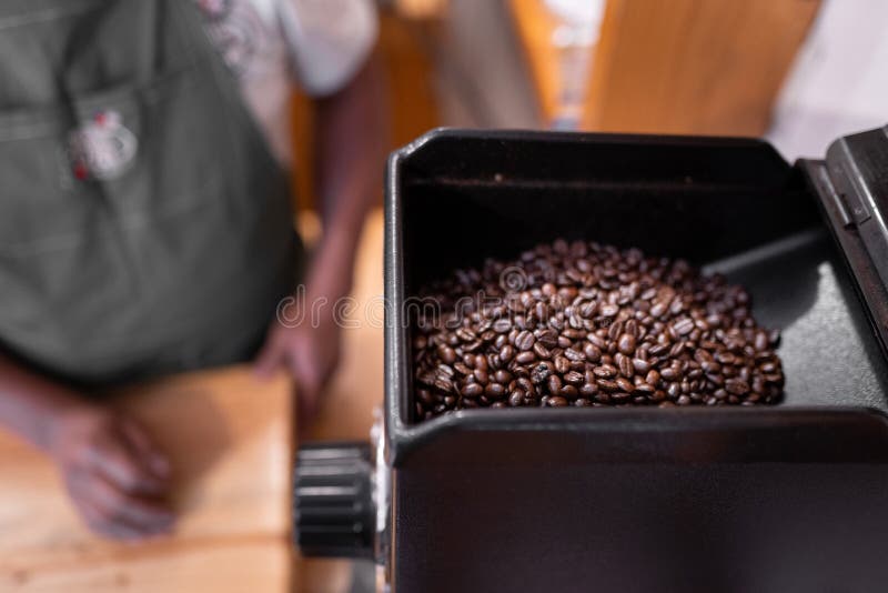Some Black Coffee Beans are Inside of the Grind Machine Hopper Stock ...