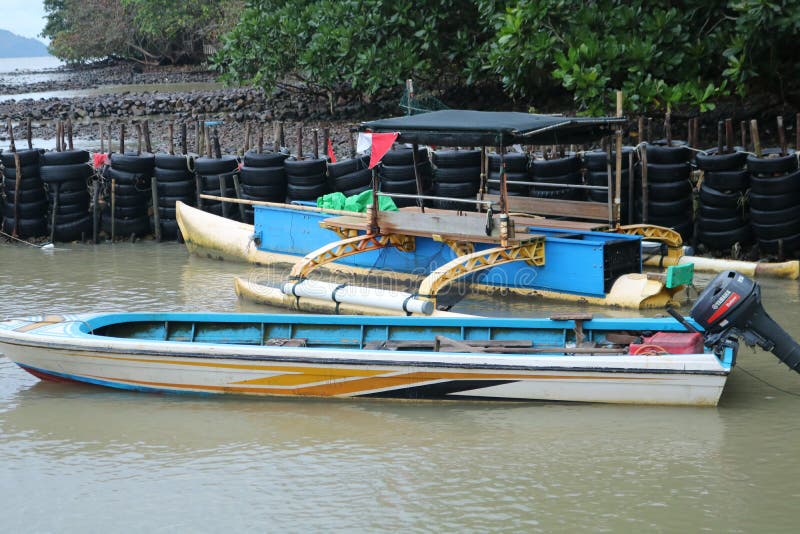 Some Boats on the Beach and Trees Stock Photo - Image of beach, canoe ...