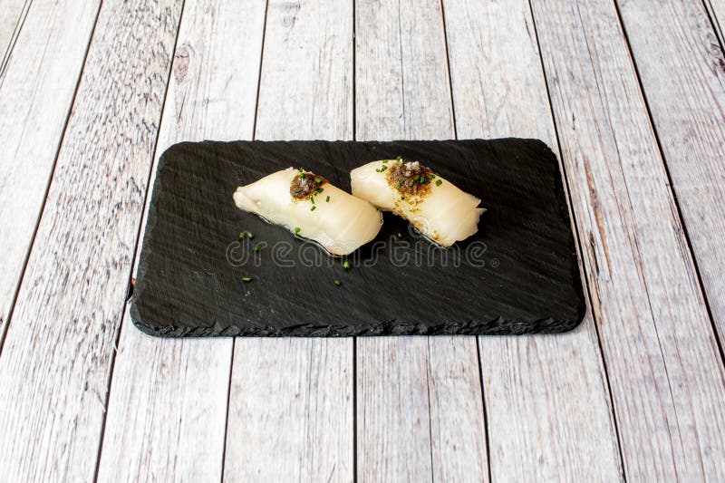 Some Delicious Lemon Fish Nigiris with Chives with Some Sauce on a ...