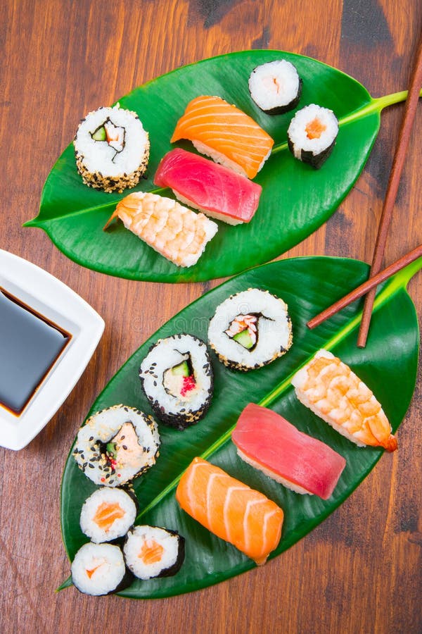 Mixed sushi on green leaf stock photo. Image of plate - 168548324